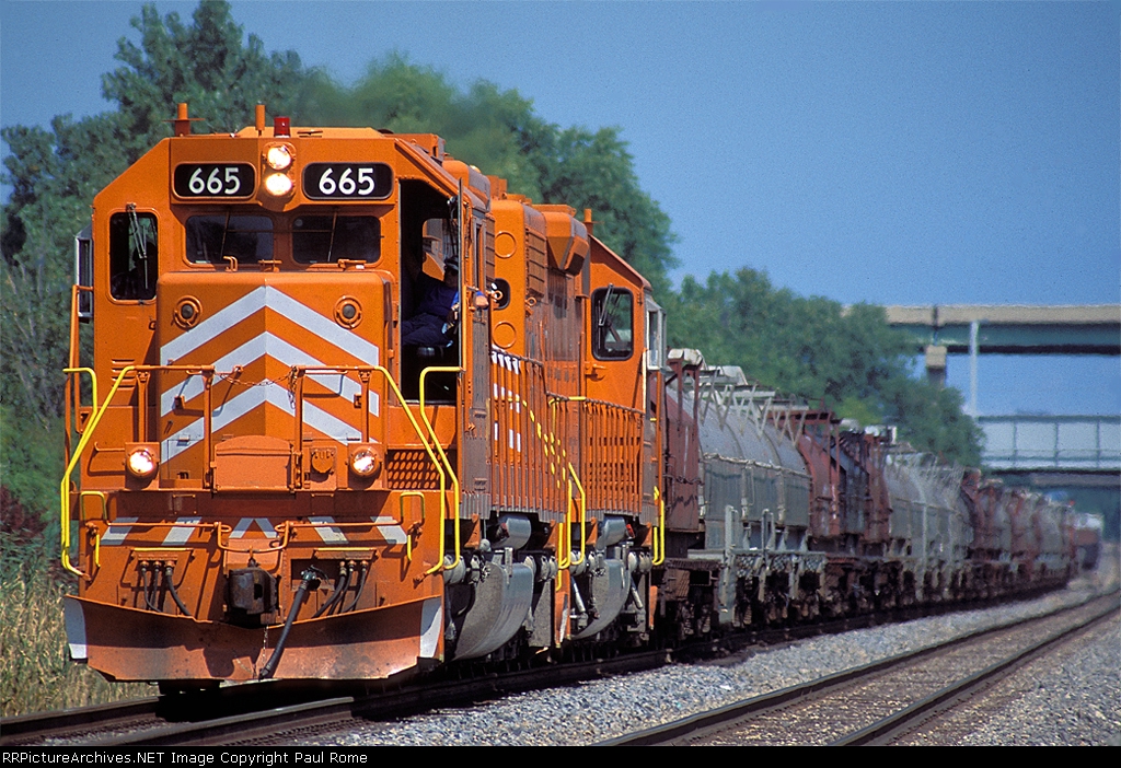 EJ&E 665, EMD SD38-2, southbound manifest heavy with coil cars on the headend